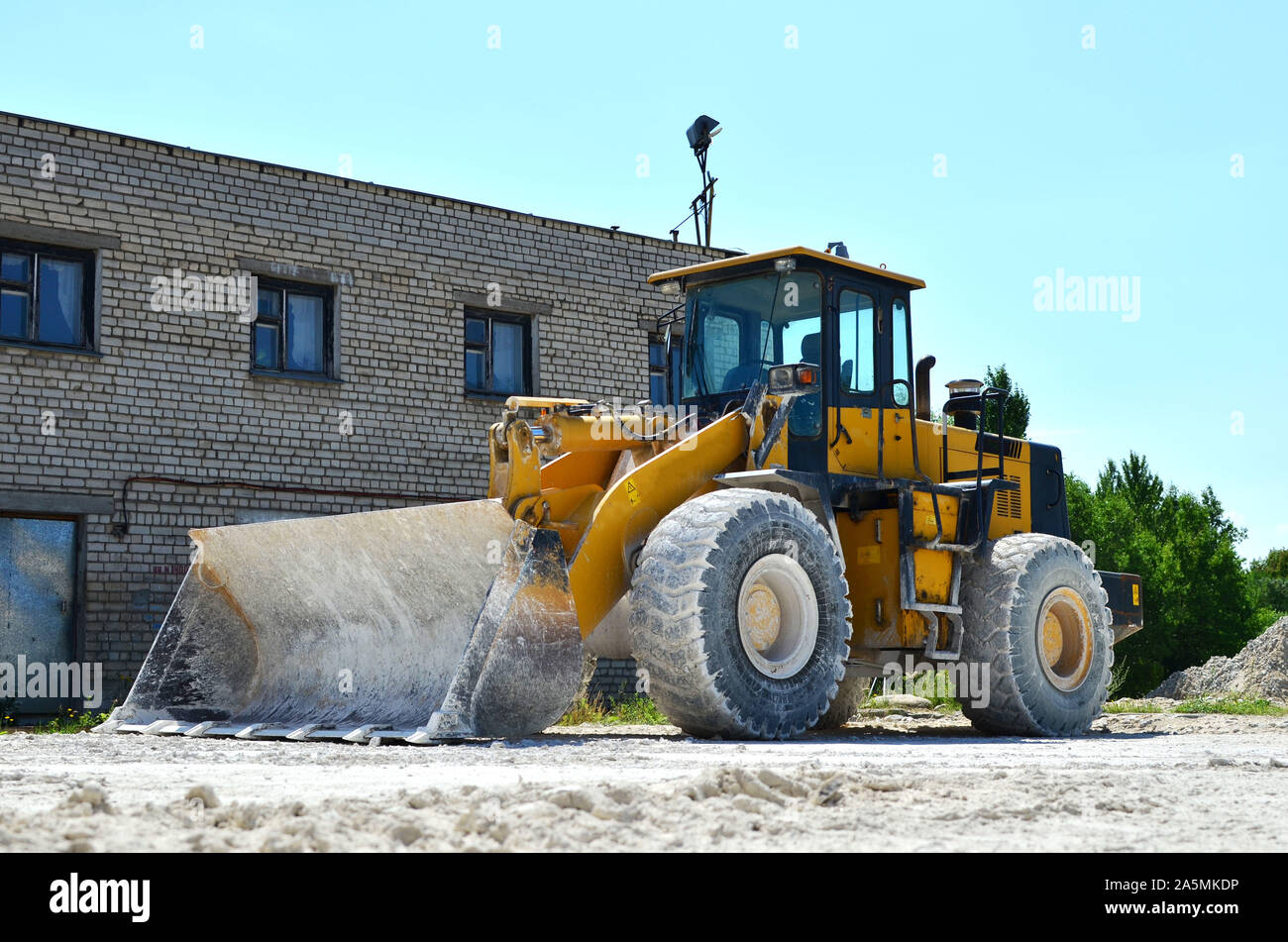 View of diesel wheel loader bulldozer with bucket on a construction ...