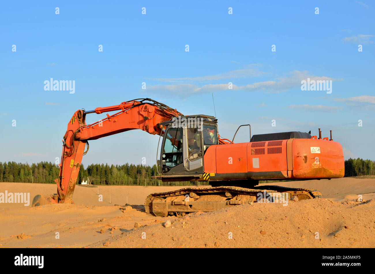 Excavator on the top of an open industrial sand pit where mining ...