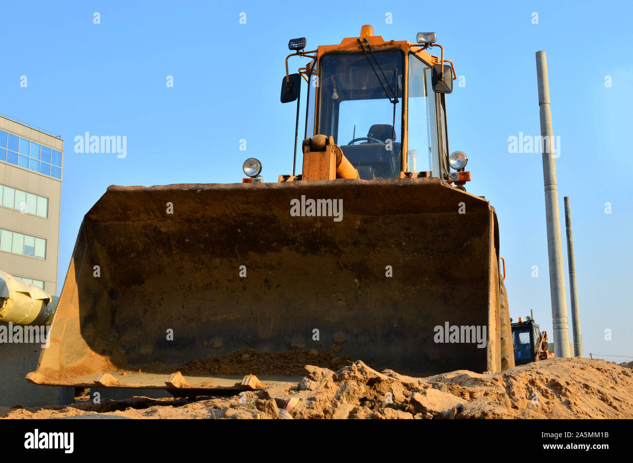 Huge iron bucket front loader close up at a construction site Stock ...