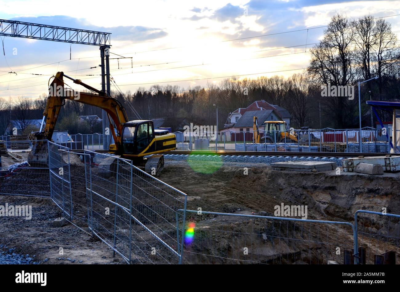 Excavator machine working on railway. Construction of the underpass ...