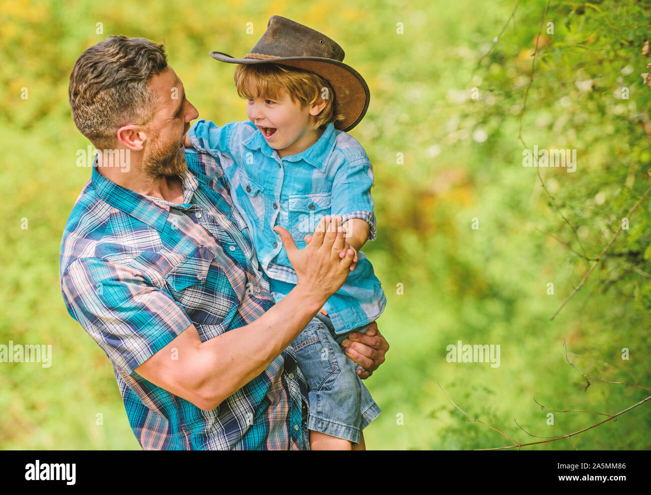 Power being father. Rustic family. Growing cute cowboy. Small helper in ...