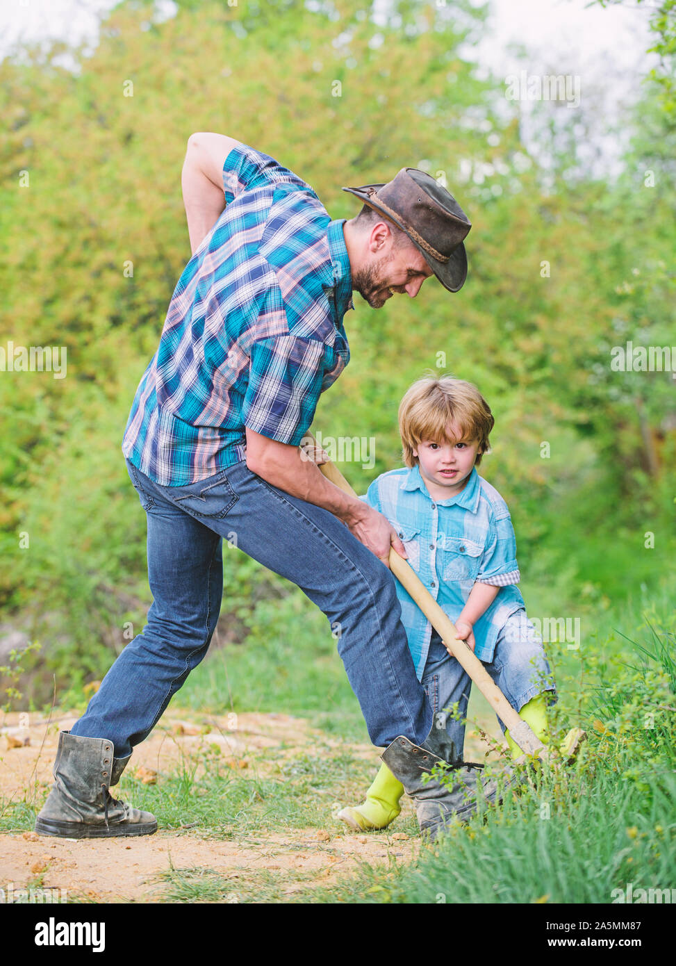 Little boy and father with shovel looking for treasures. Happy ...