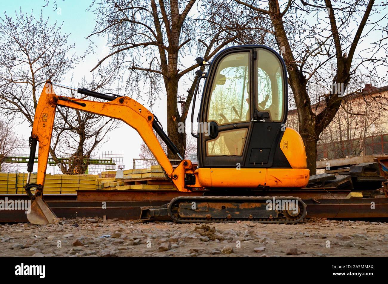 Mini excavator on a construction site, on a street reconstruction Stock ...