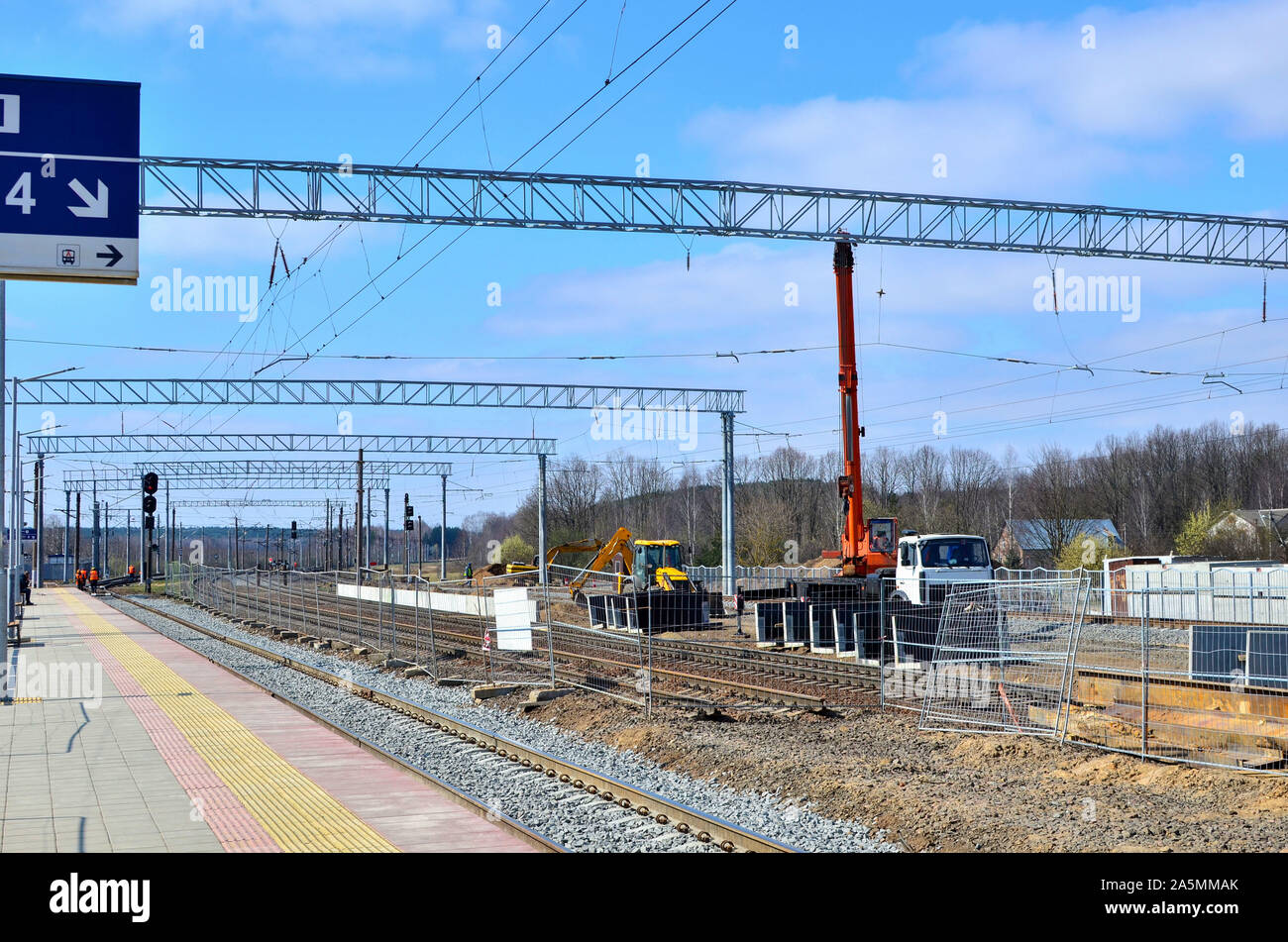 Crane and excavator work on the construction site on the railway ...