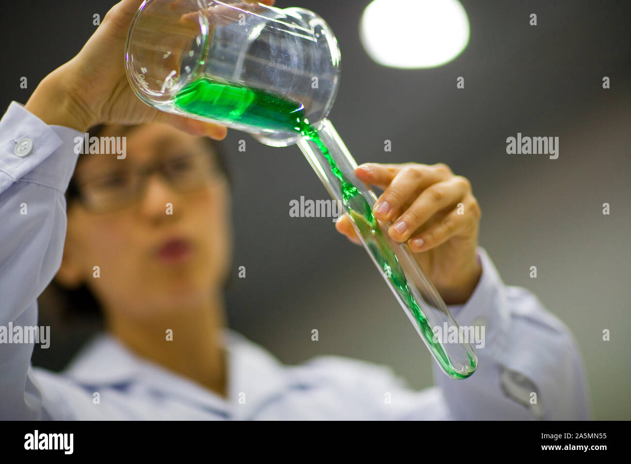 Liquid being poured into a test tube Stock Photo - Alamy
