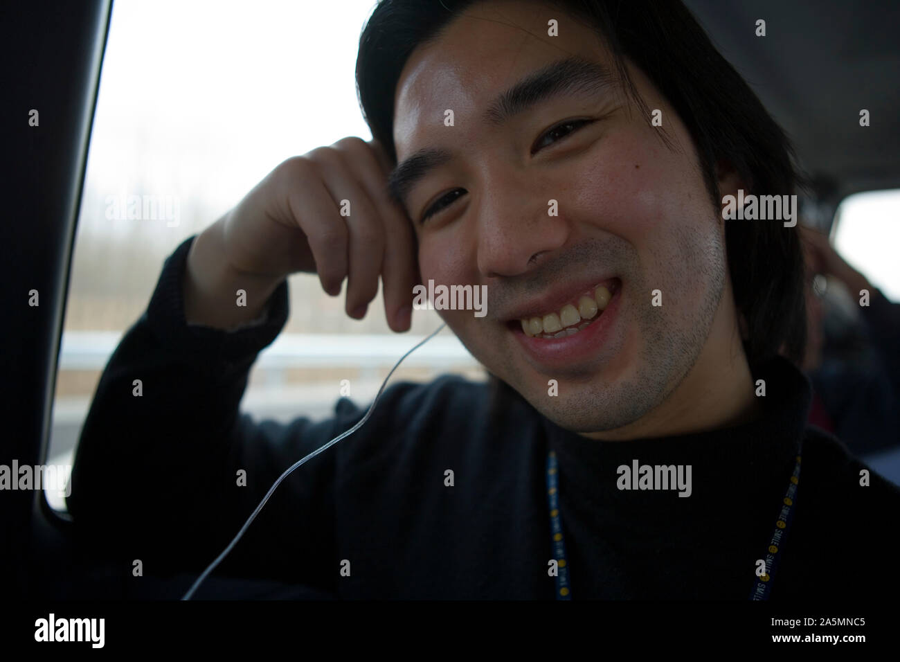 Portrait of smiling Chinese man sitting in a car Stock Photo - Alamy