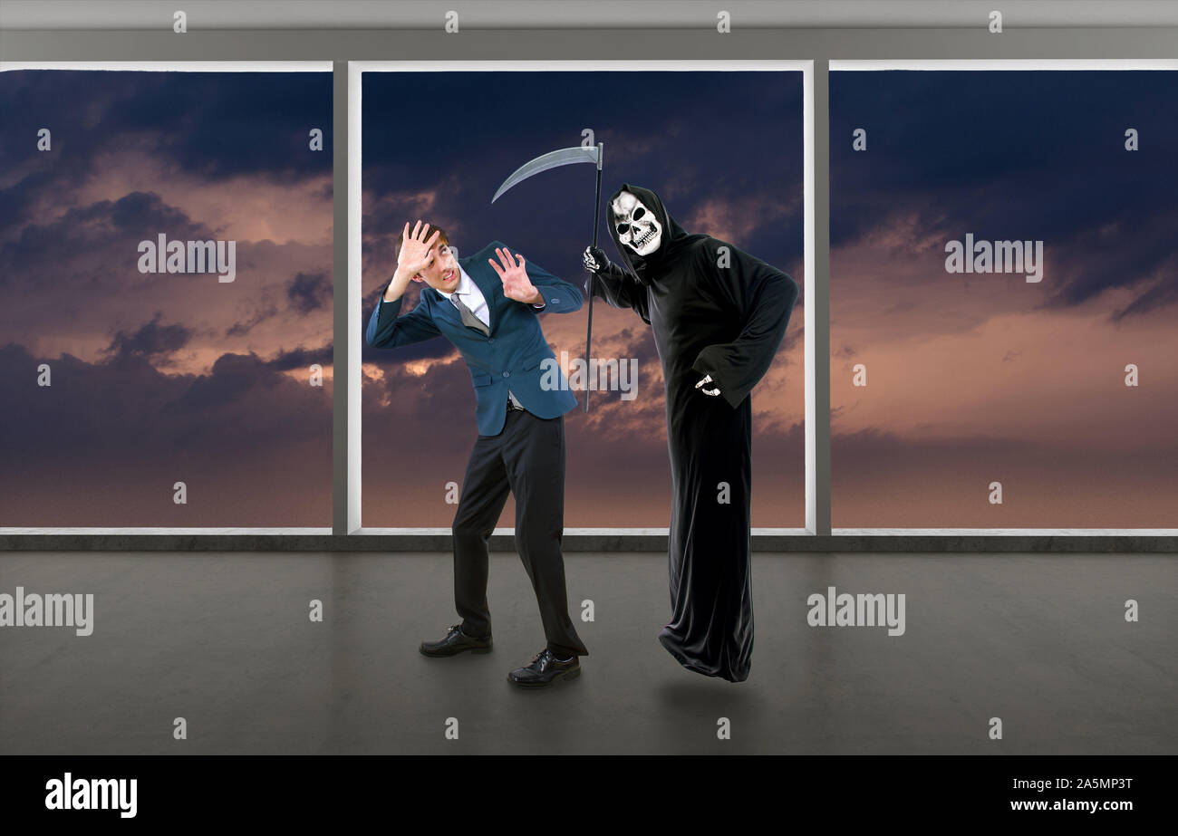 Man in a Halloween grim reaper ghost costume chasing, mocking and ...