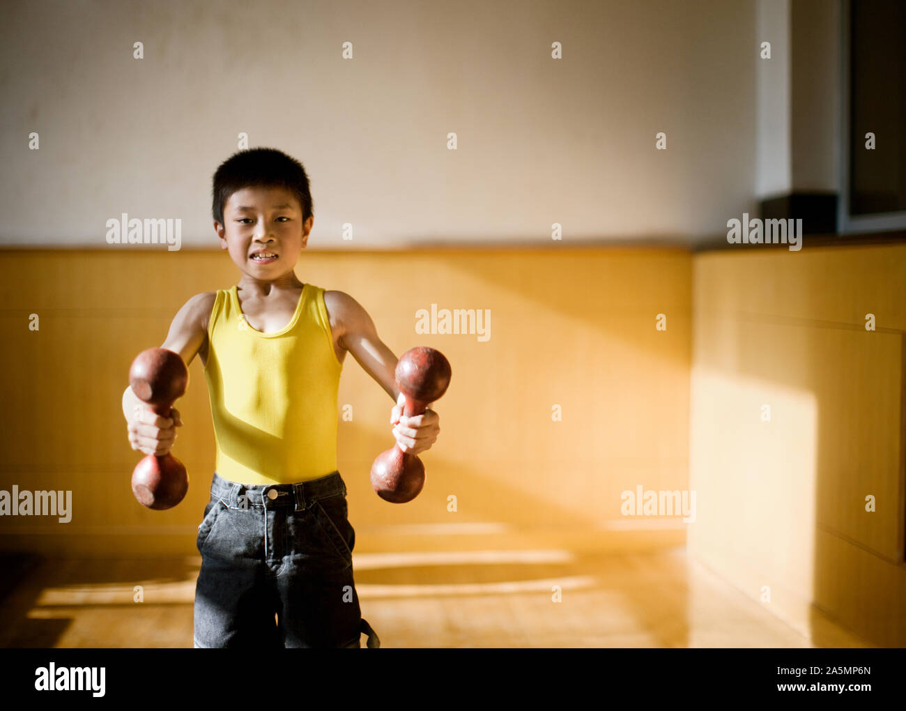 Boy lifting weights hi-res stock photography and images - Alamy