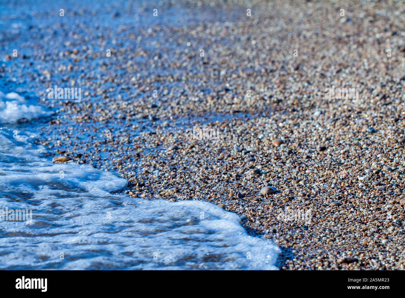 sea pebbles colored granite on the beach background stones. The shore ...