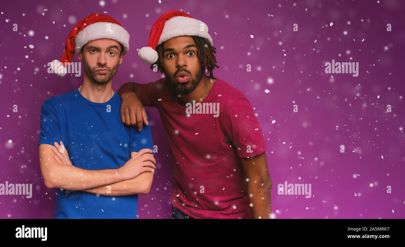 Amazed friends surprised by the arrival of Christmas. Purple background ...