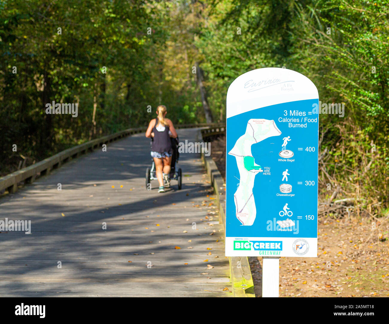Pushing Stroller Past Calorie Sign Stock Photo - Alamy
