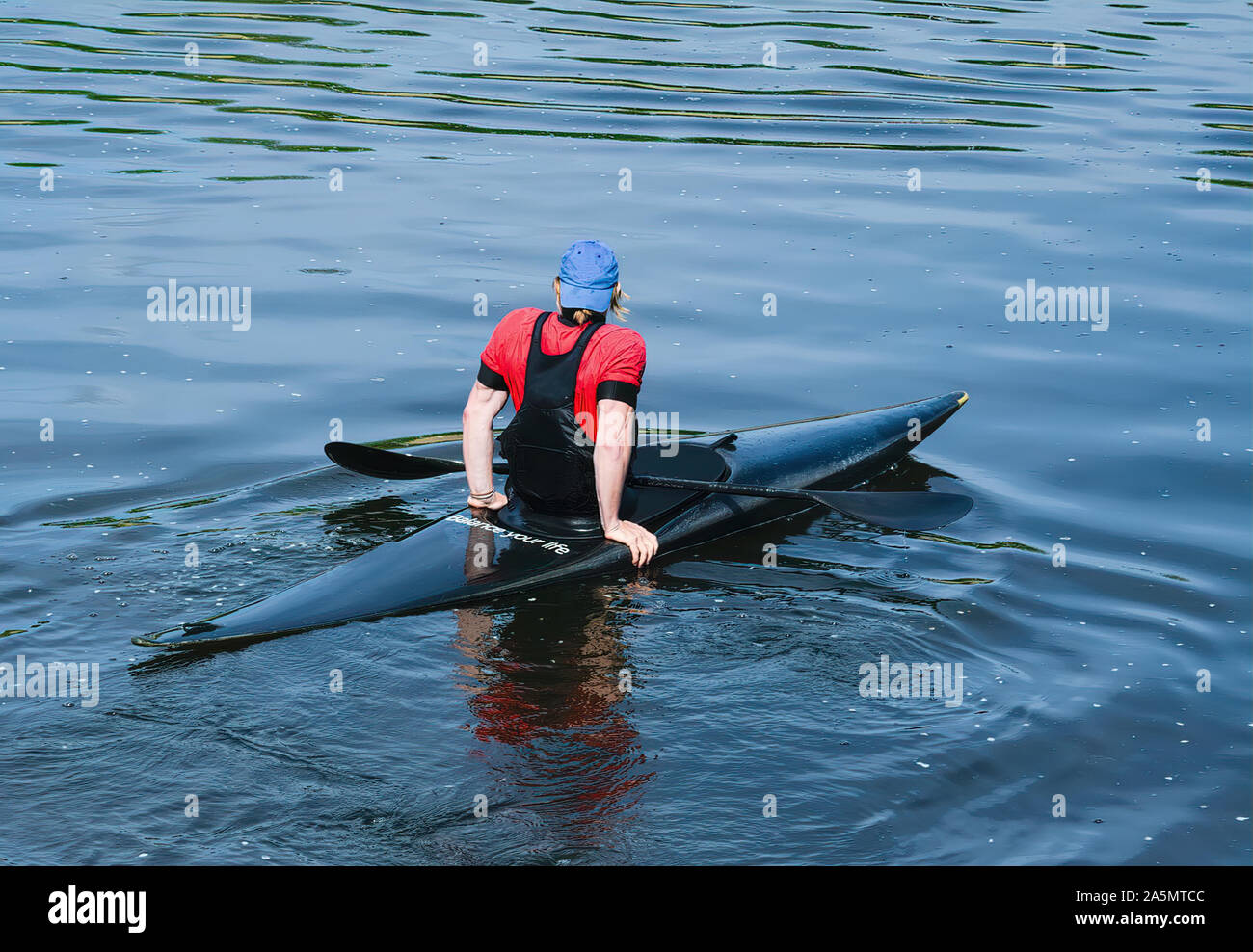 Young athlete floating on kayak on the river alone Stock Photo - Alamy