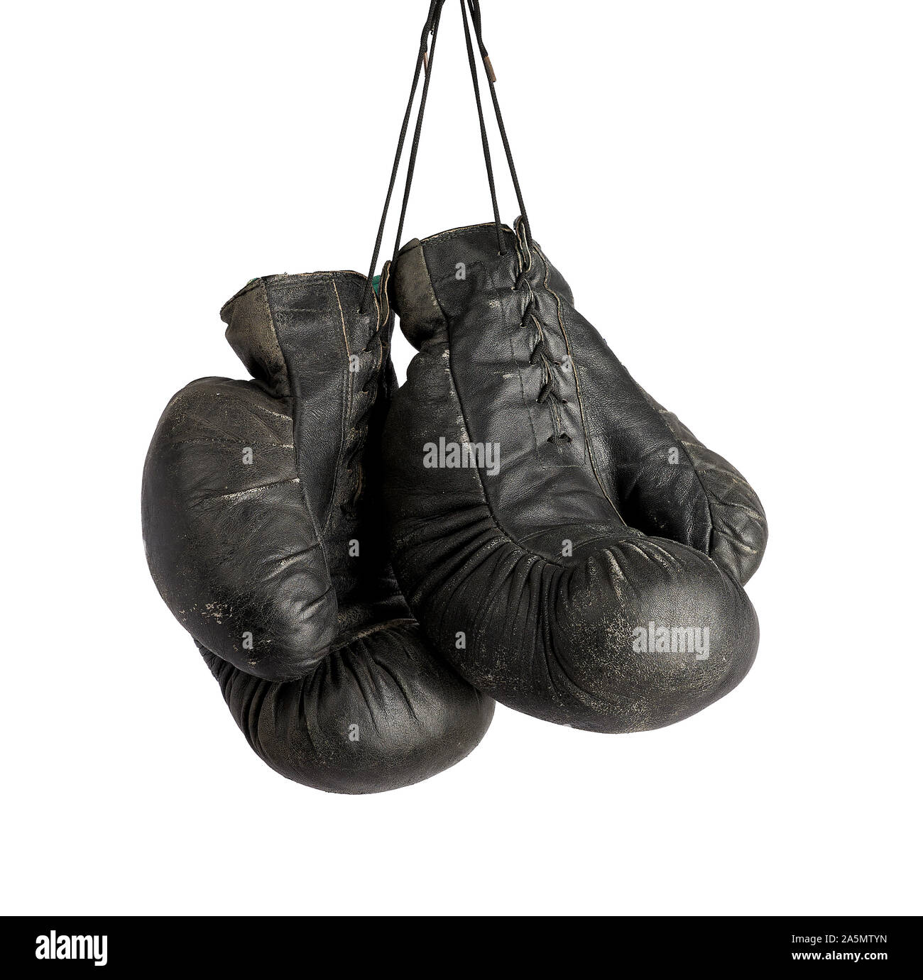 pair of very old vintage black leather boxing gloves hanging on a rope ...
