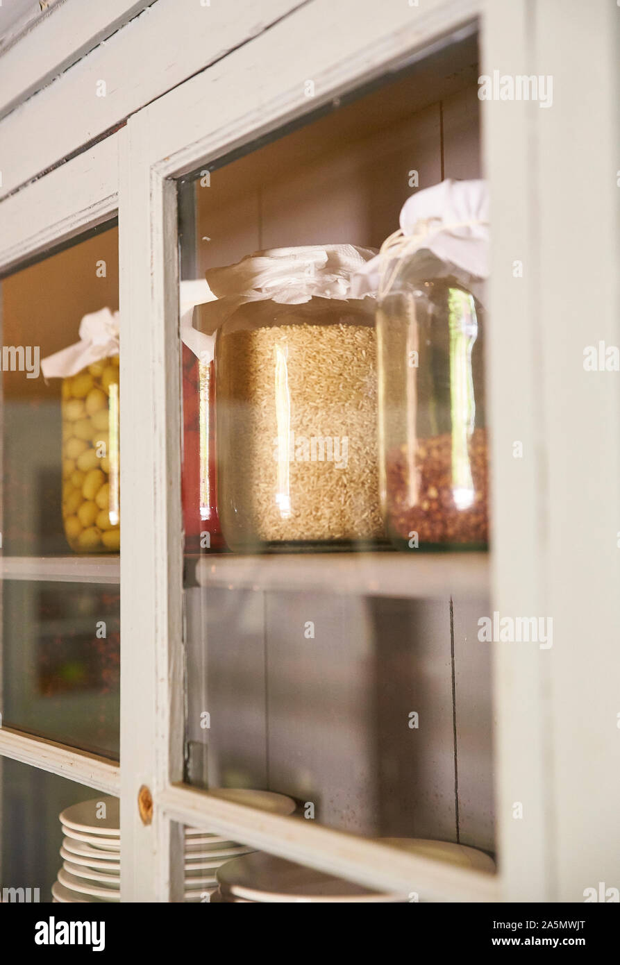 rural kitchen cupboard jars for country stay Stock Photo - Alamy