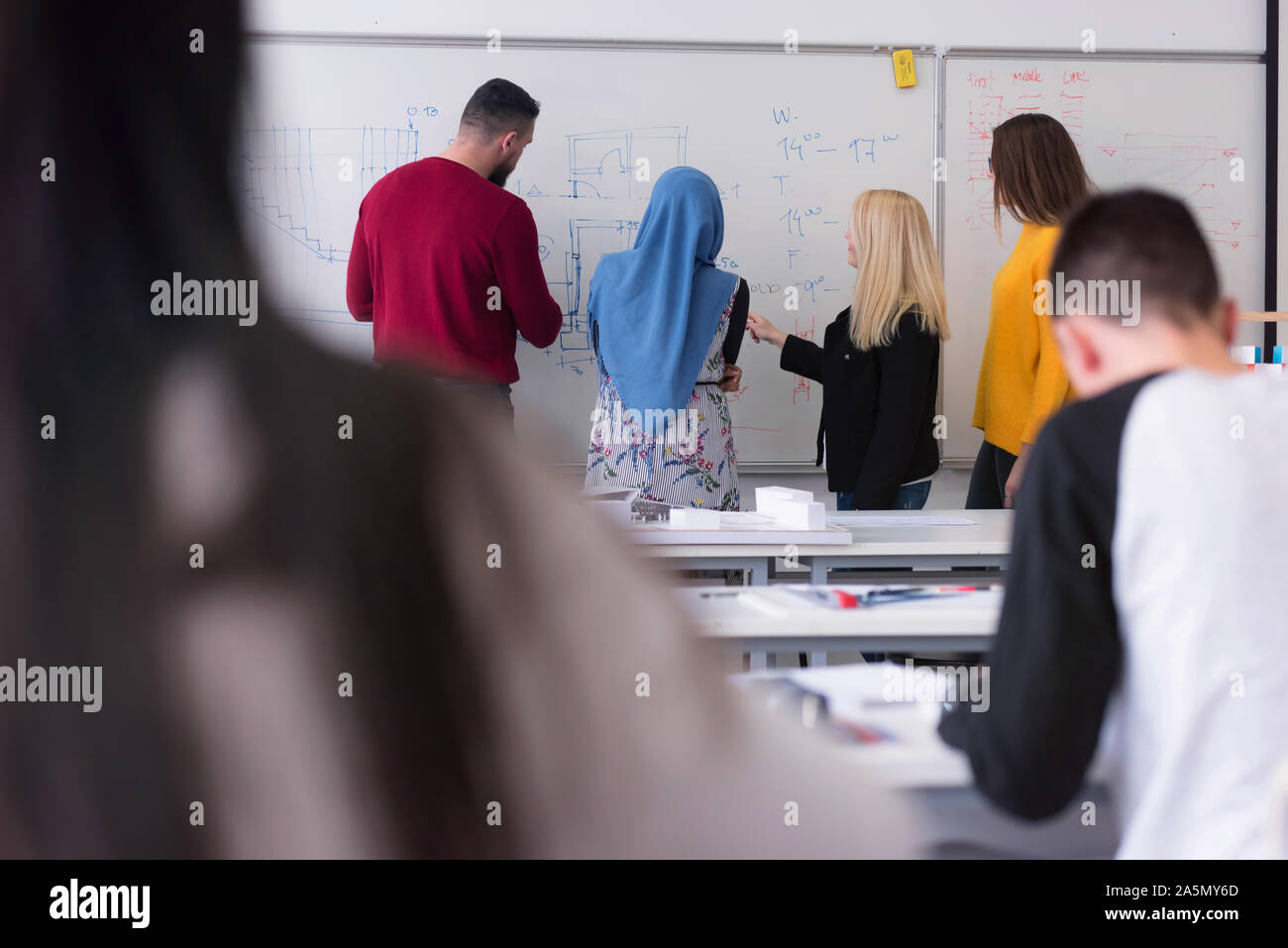 Female Architecture teacher at work. Female professor explain ...