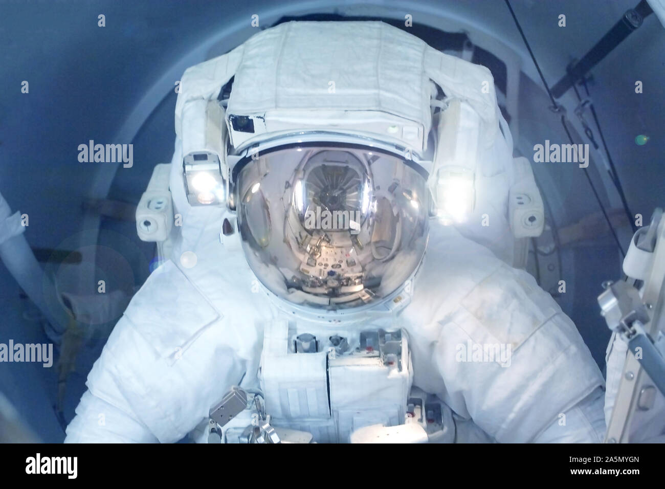 Astronaut in a spacesuit in open space. Elements of this image were ...