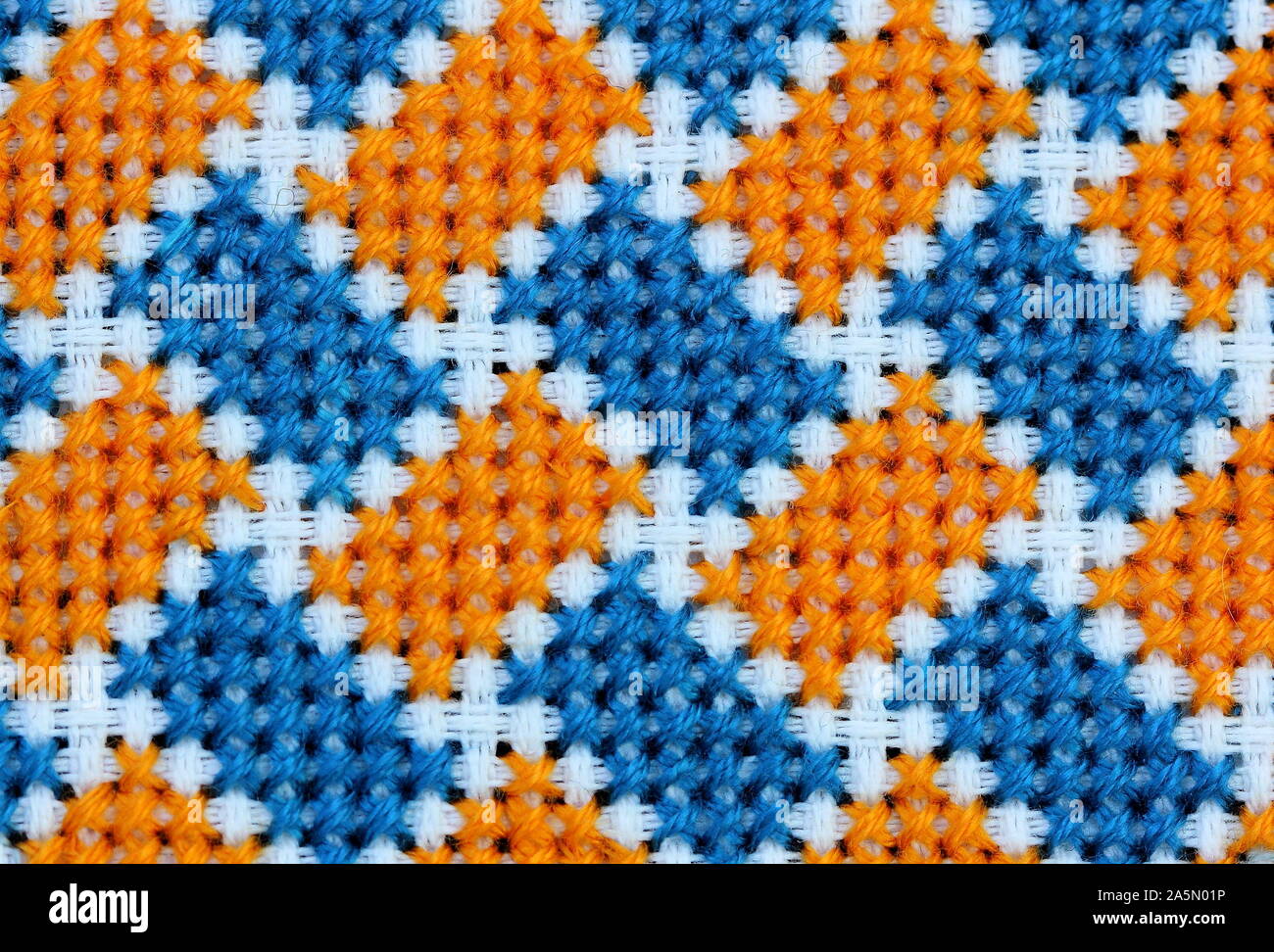 Embroidery in blue and orange Stock Photo - Alamy