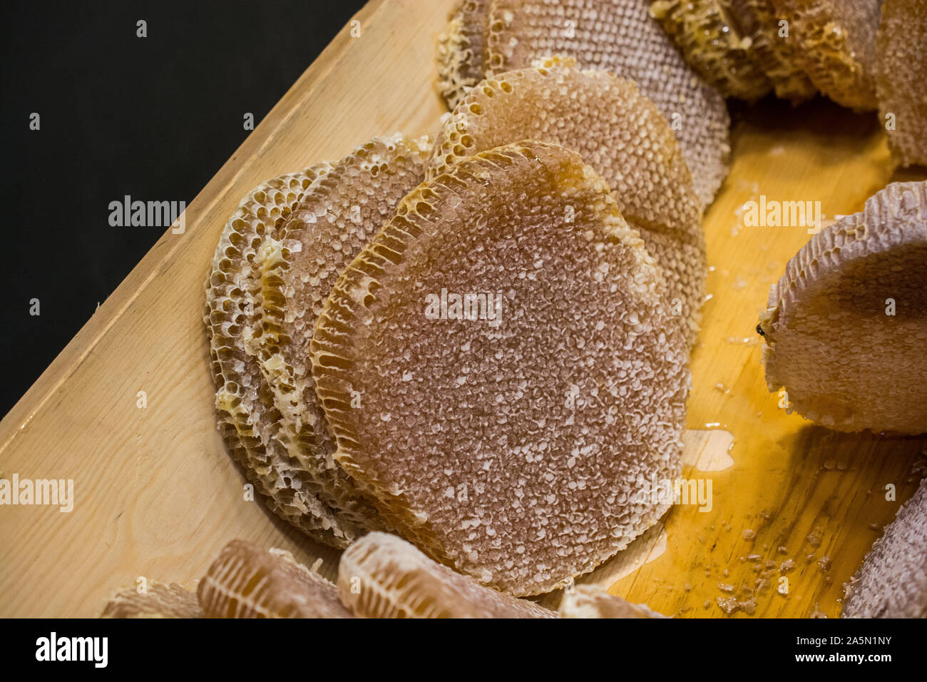 Honey in honeycomb from round beehive with sweet honey Stock Photo - Alamy