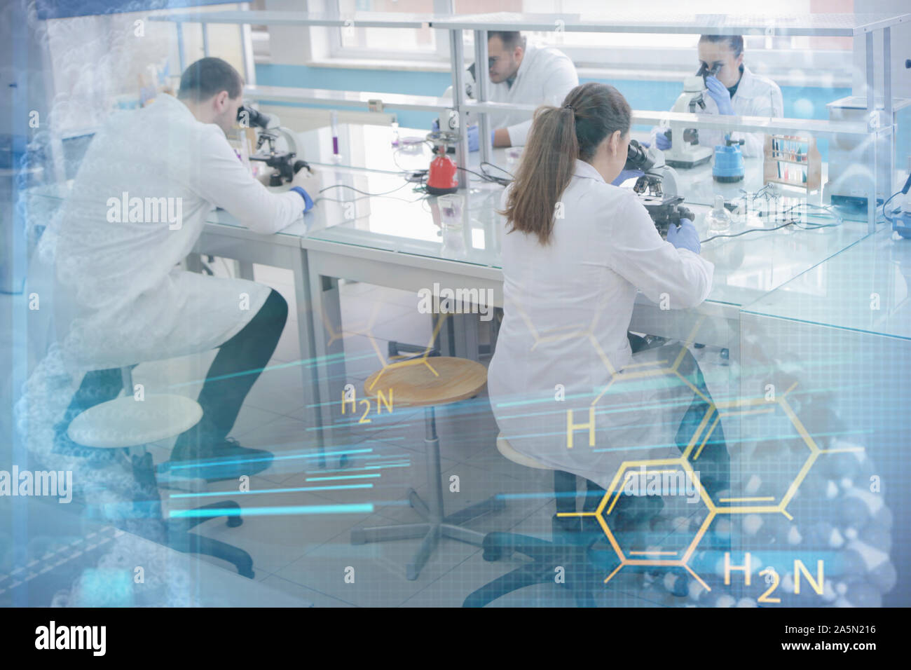 Group of young Laboratory scientists working at lab with test tubes and ...