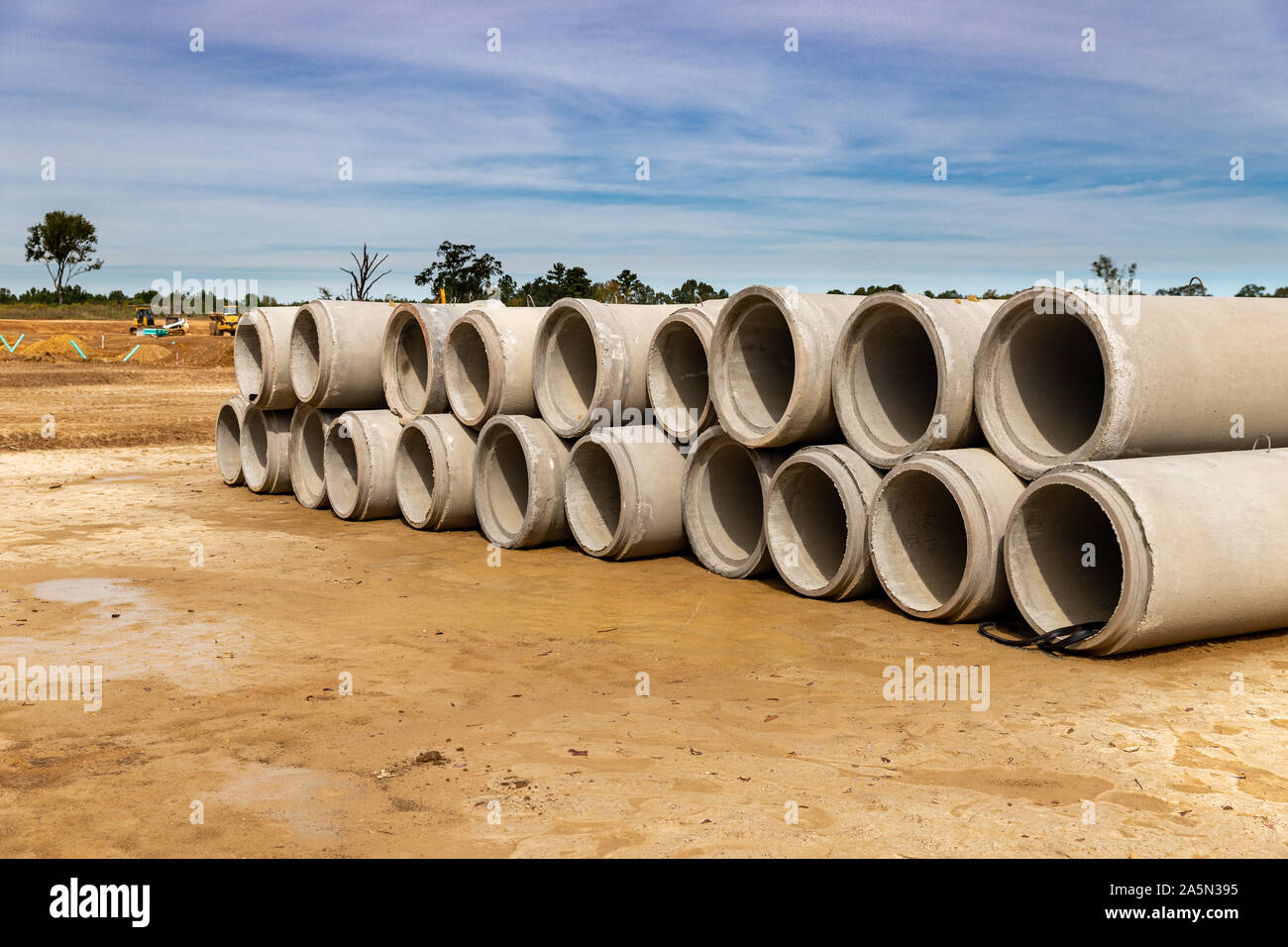 Precast Concrete Drainage pipes stacked up on construction site for new ...