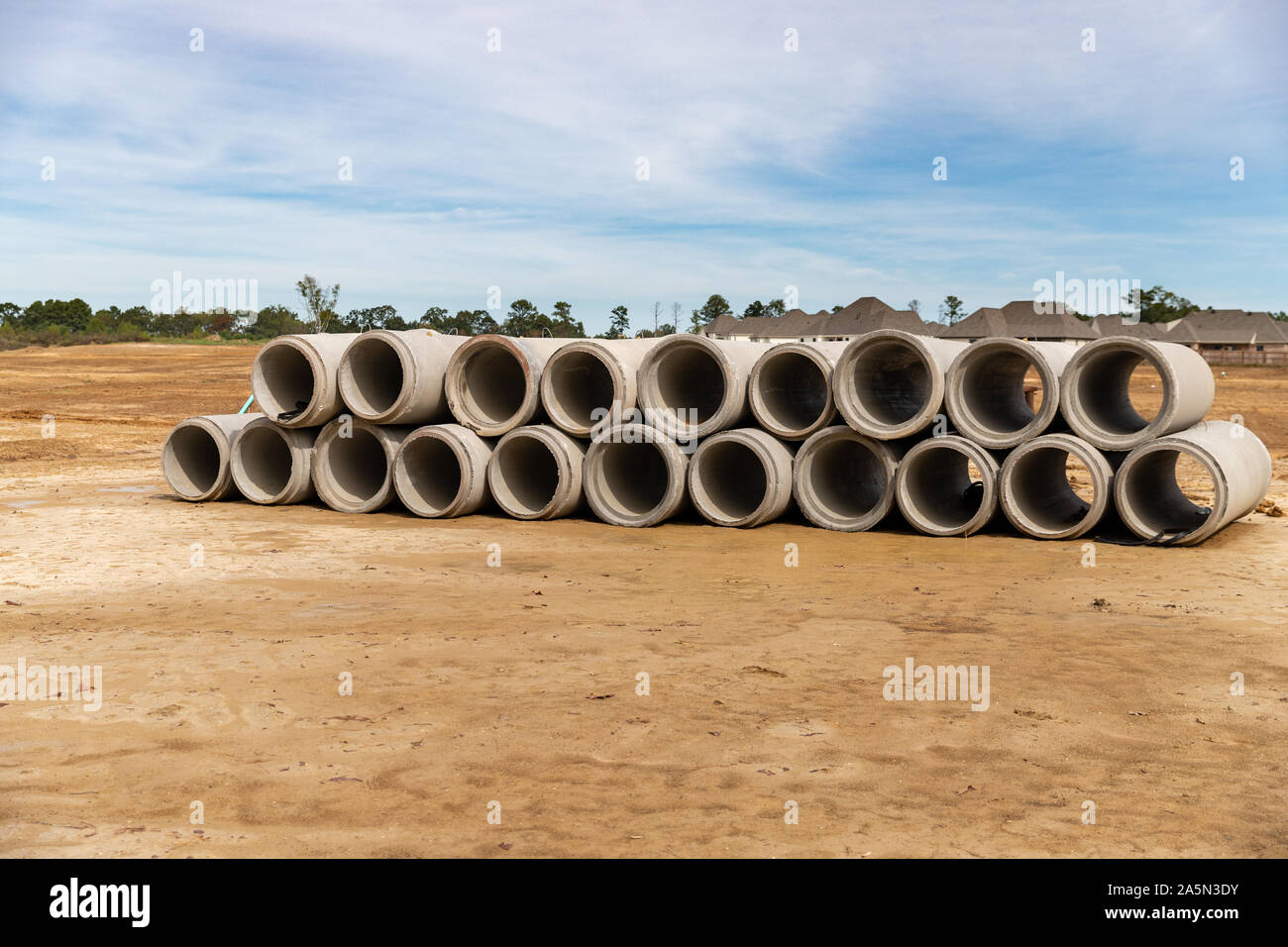 Precast Concrete Drainage pipes stacked up on construction site for new ...