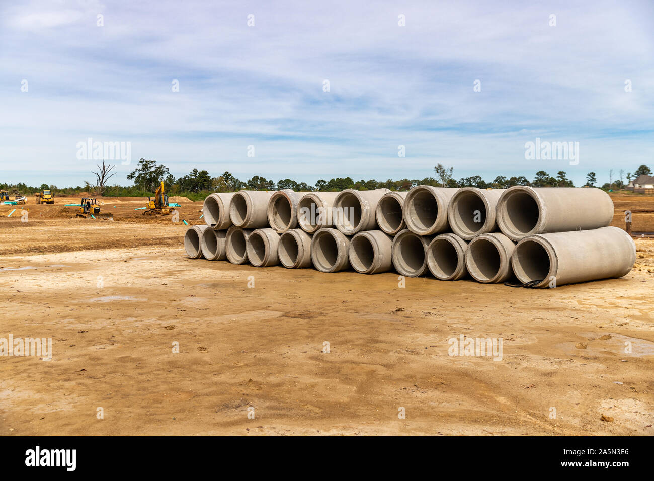 Precast Concrete Drainage pipes stacked up on construction site for new ...