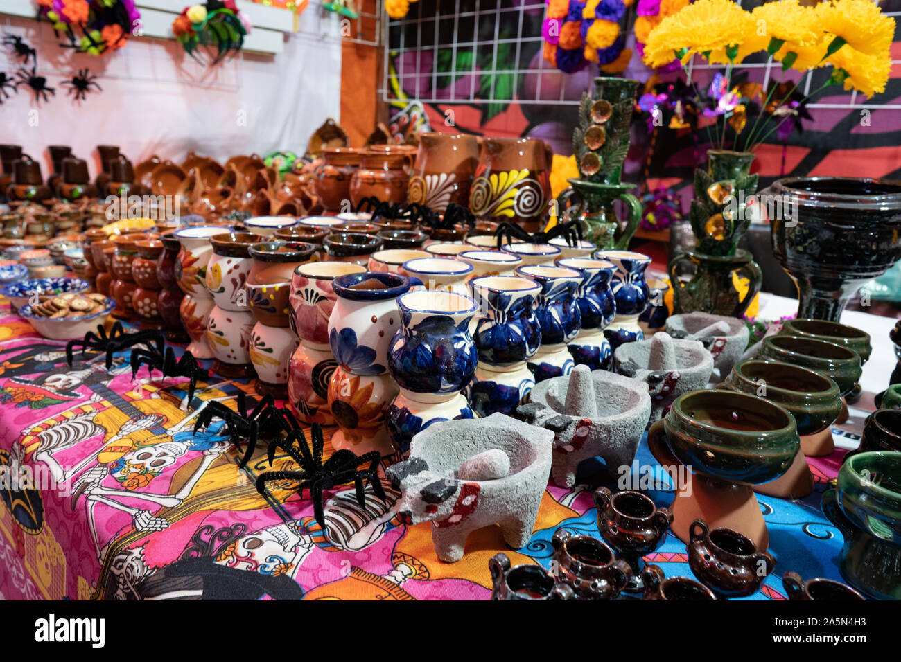 Day of the dead decorations are being displayed at a market stall in ...