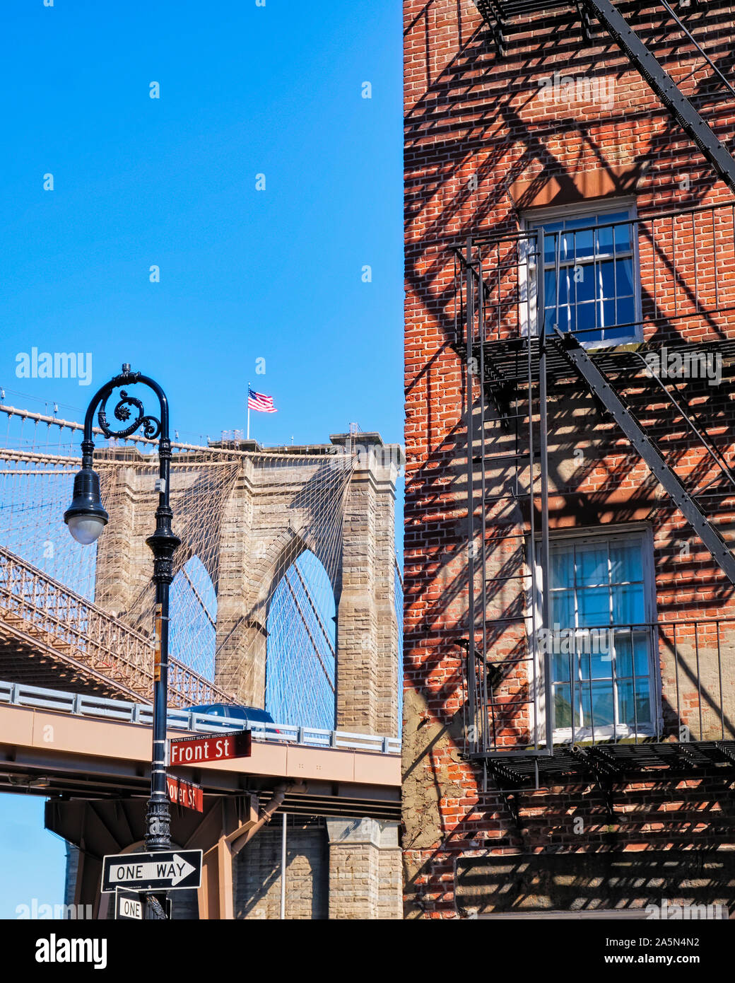 Brooklyn Bridge Stone Tower View and a Typical House with Fire Escapes ...