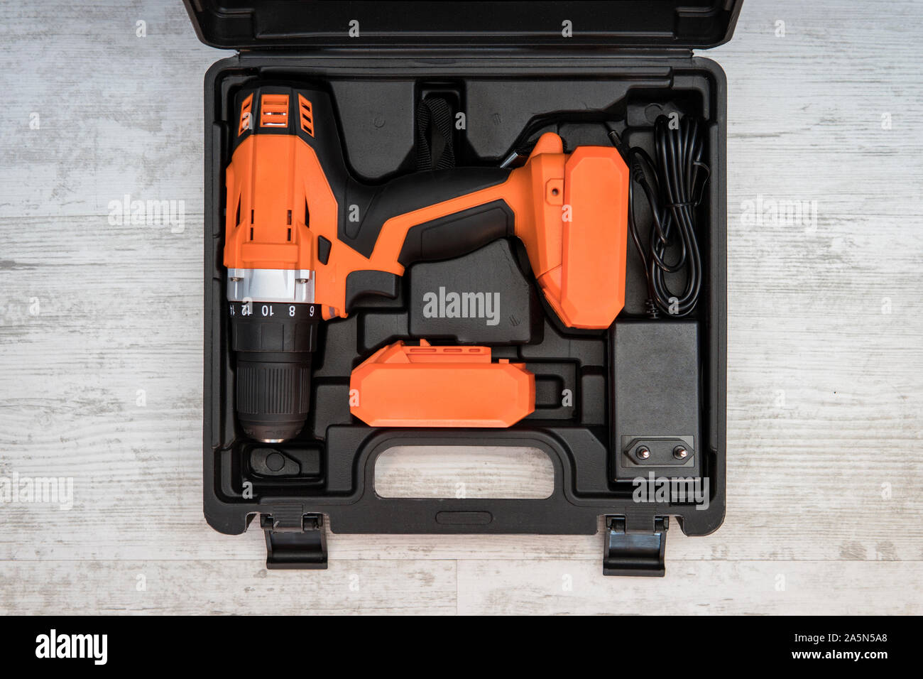 Top view of electric screwdriver on white background. orange ...