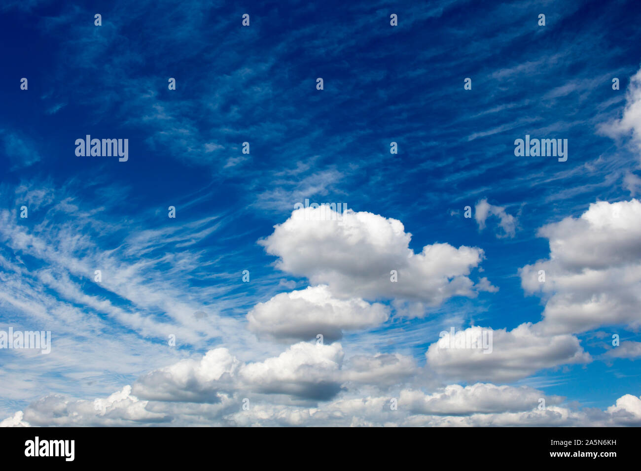 Fluffy white cumulus cumulostratus cloud formations on a spring ...