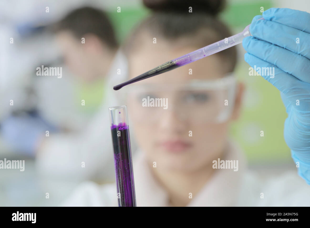 Two Young Female and male Laboratory scientists working at lab with ...