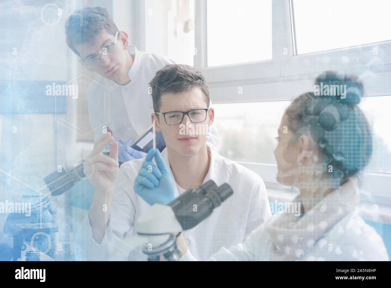Group of young Laboratory scientists working at lab with test tubes and ...