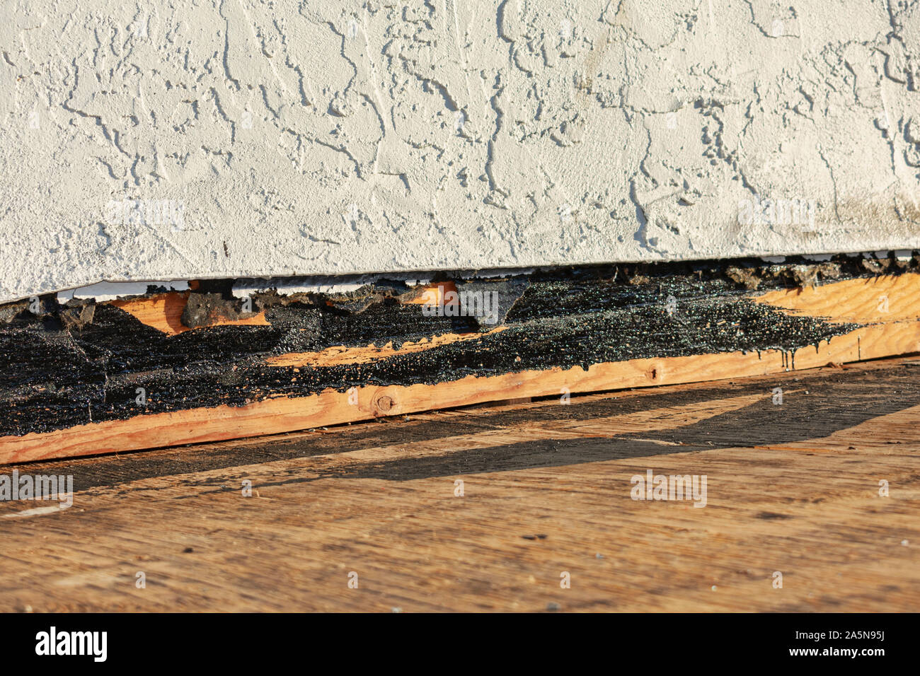 Roof repair and replacement work in progress. Stucco sidewall and flat ...