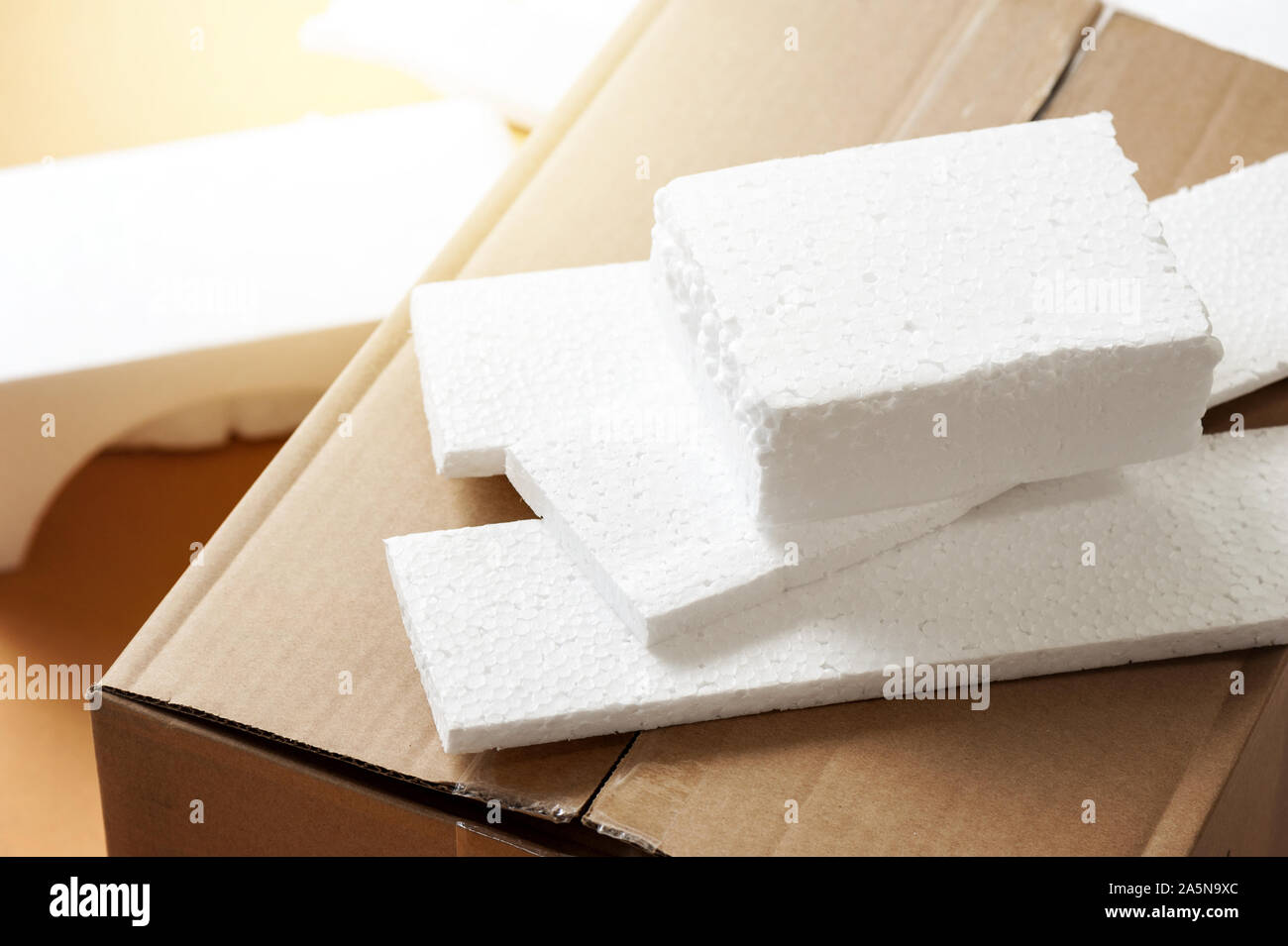 Closeup white polystyrene foam on the cardboard. Polystyrene foam is ...