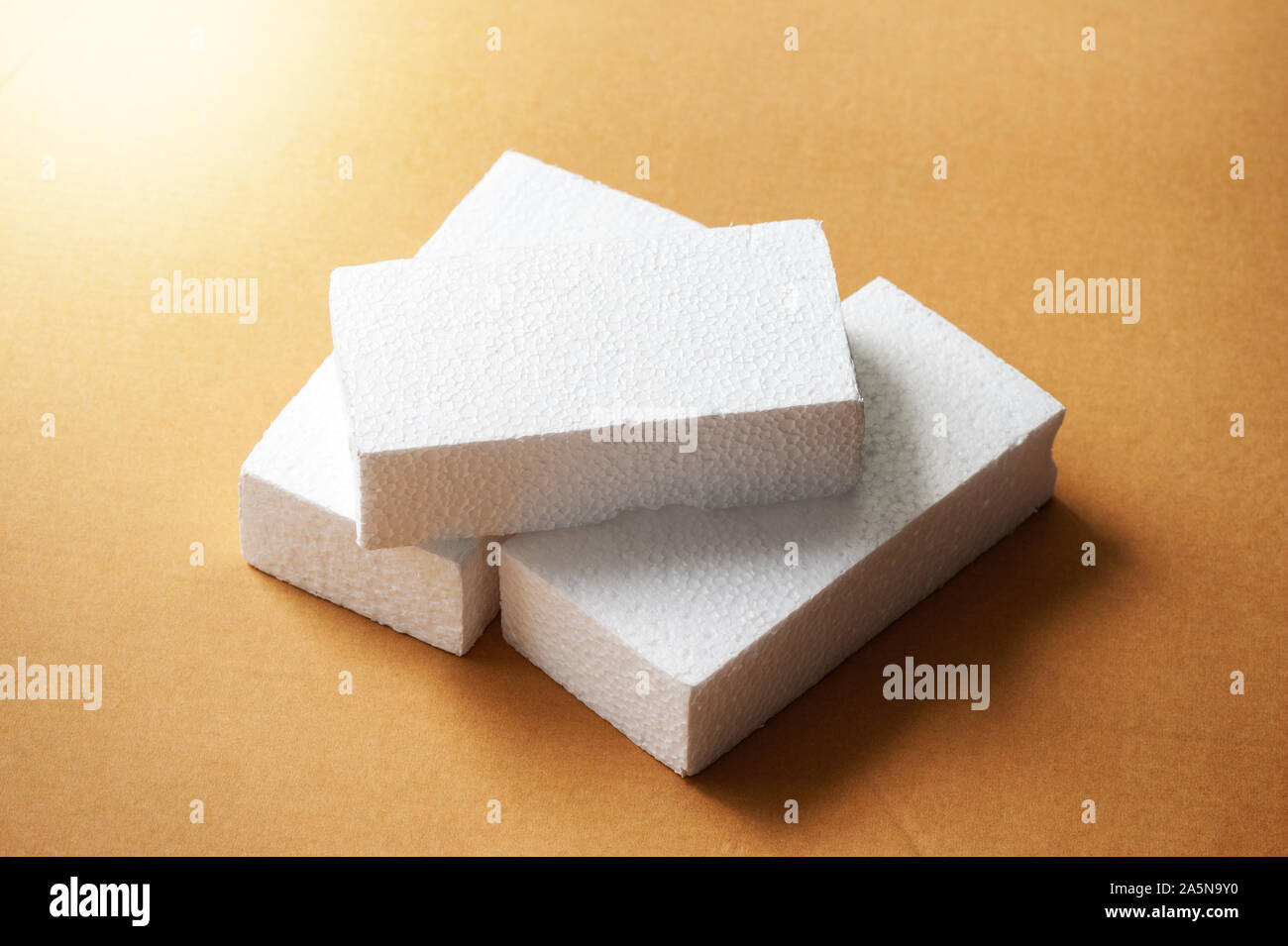 Closeup white polystyrene foam on the cardboard. Polystyrene foam is ...