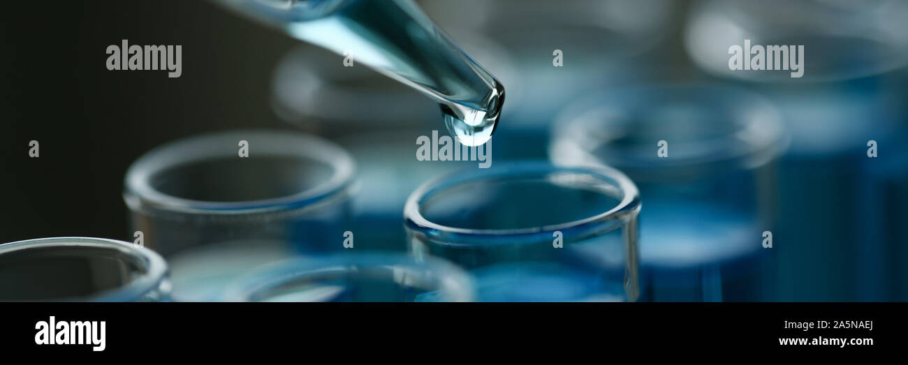 Test tube of glass overflows liquid solution potassium Stock Photo - Alamy