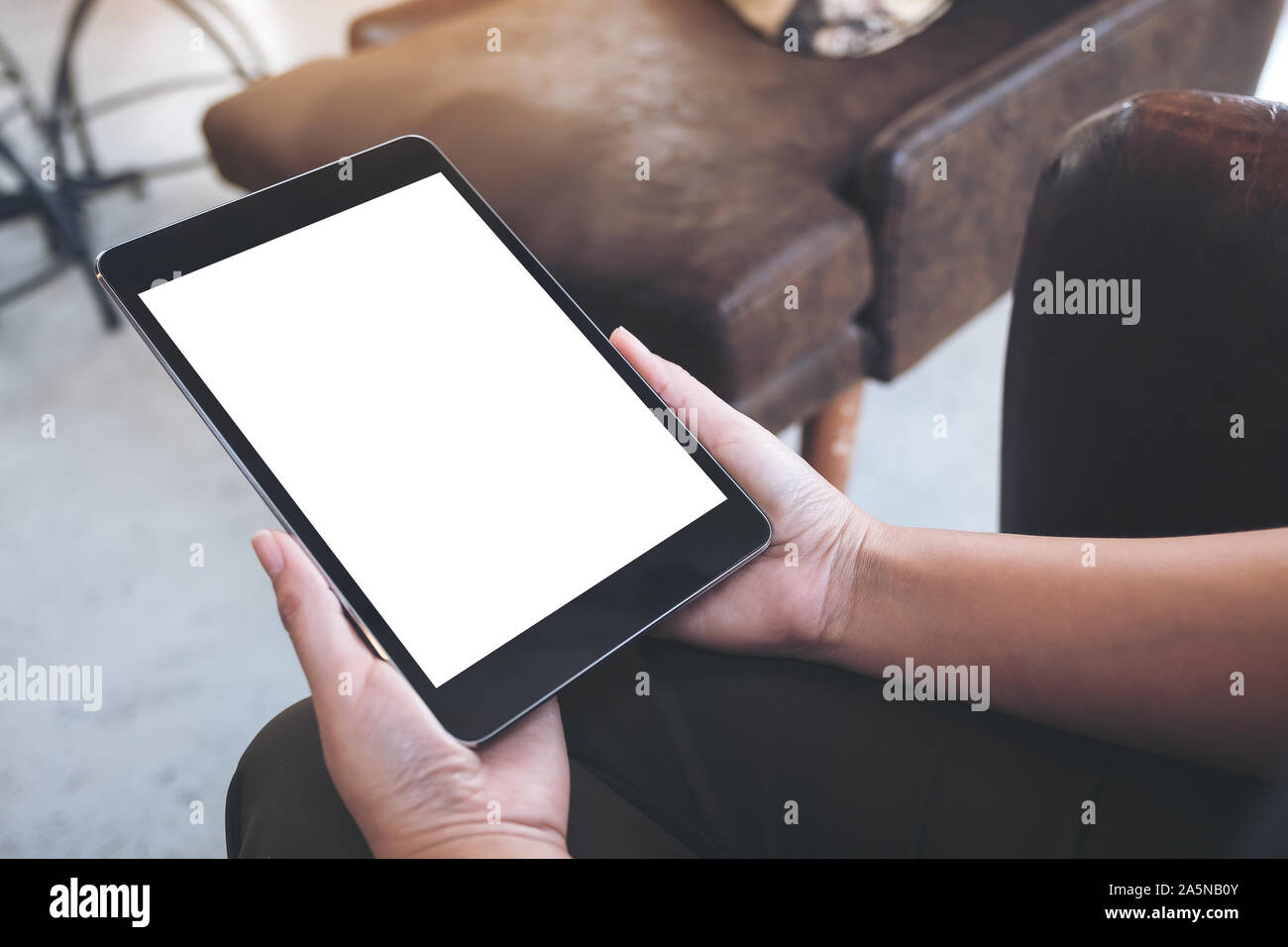 Mockup image of hands holding black tablet with blank white desktop ...