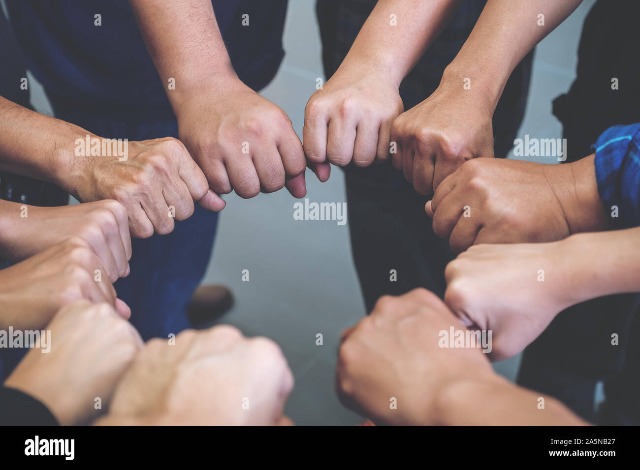 Many hands holding together sign hi-res stock photography and images ...