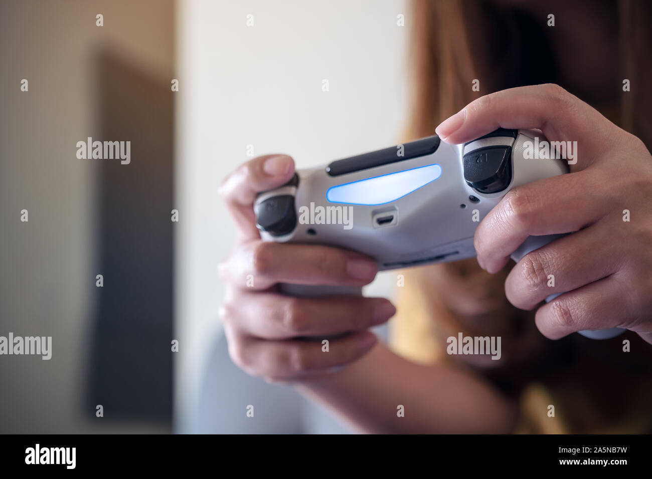 Closeup image of hands holding the game controller while playing games ...
