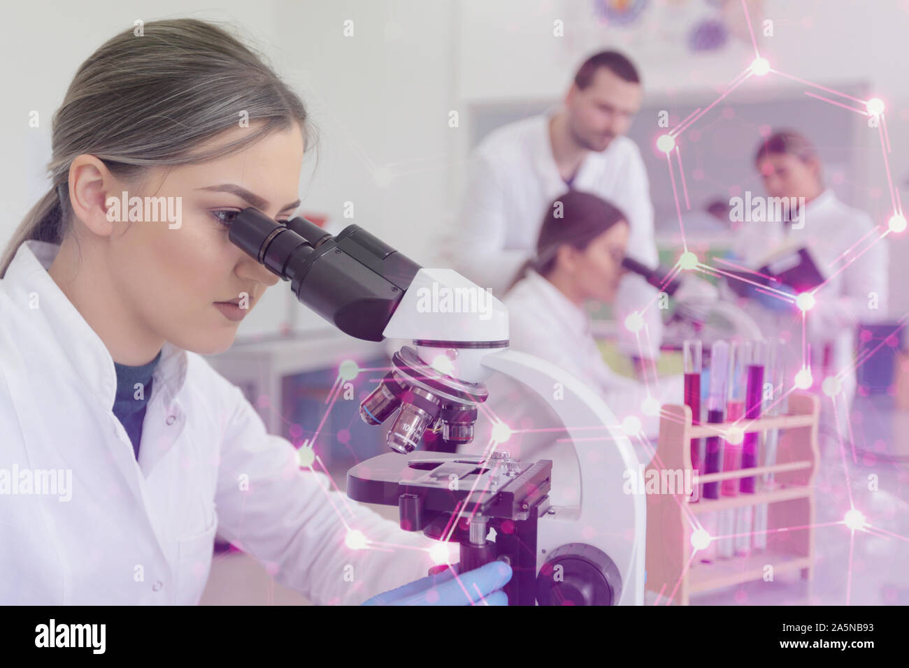 Group of young Laboratory scientists working at lab with test tubes and ...