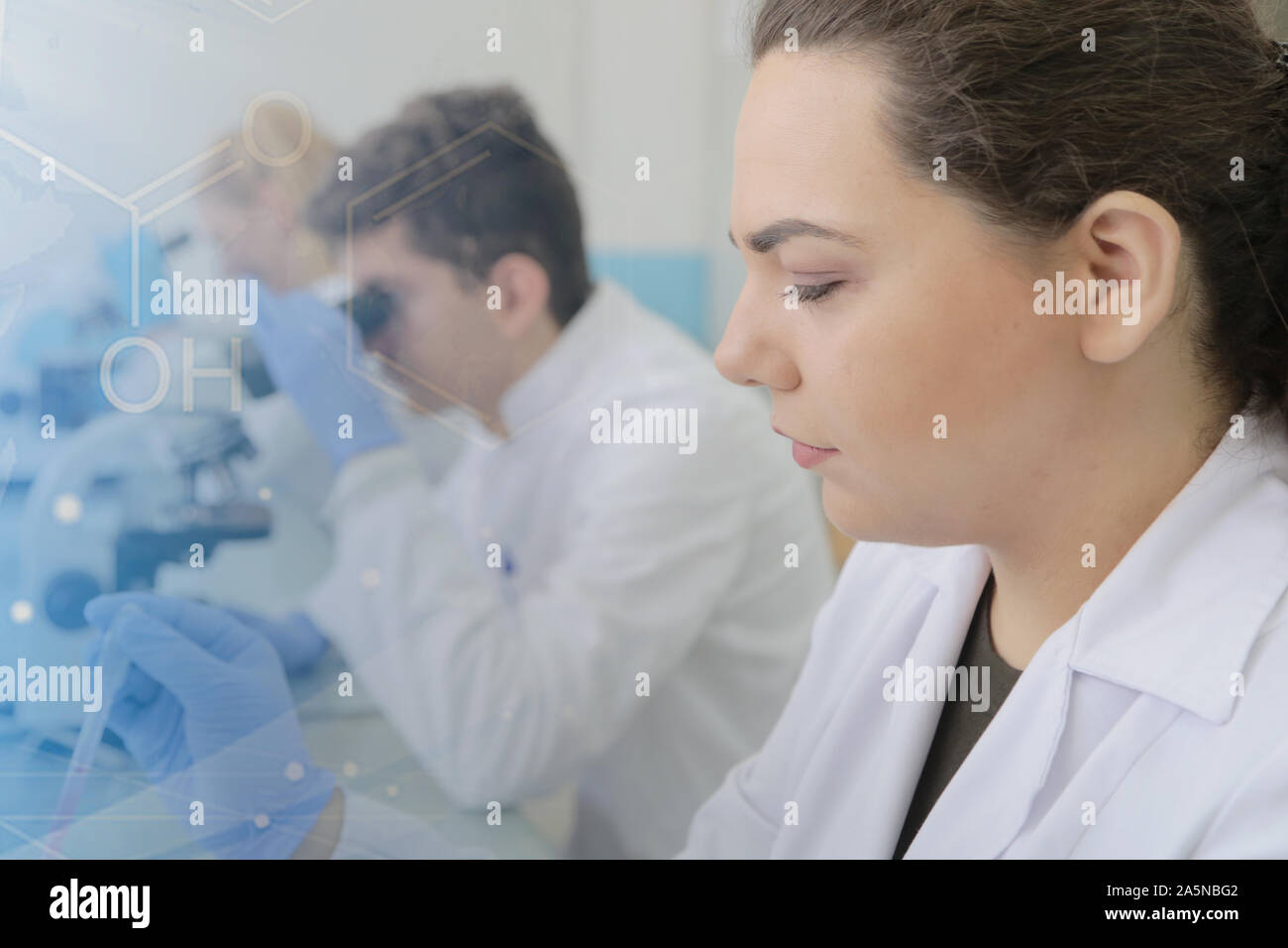 Group of young Laboratory scientists working at lab with test tubes and ...