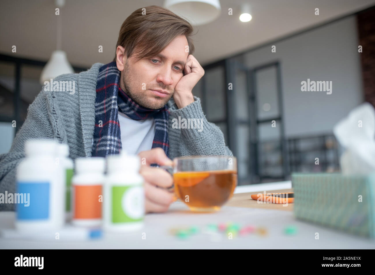 Man feeling lonely and bored while having flu Stock Photo - Alamy