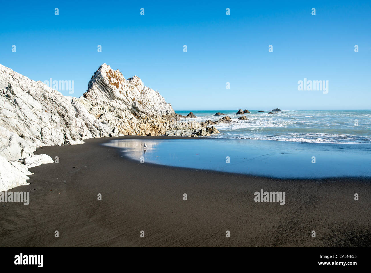 The contrast of the black sand beach and the dramatic white rock at ...