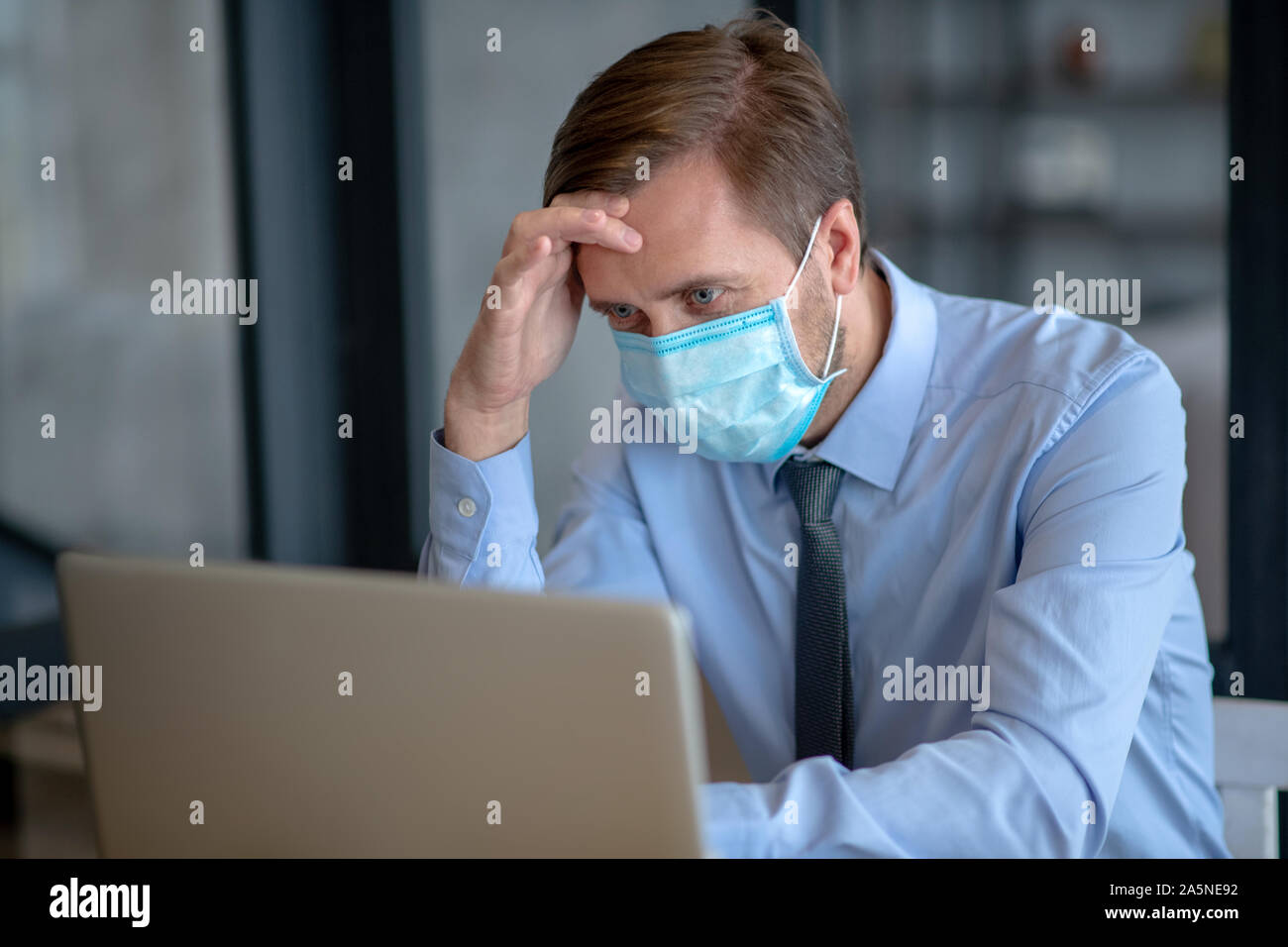 Sick man wearing shirt and tie working on computer Stock Photo - Alamy