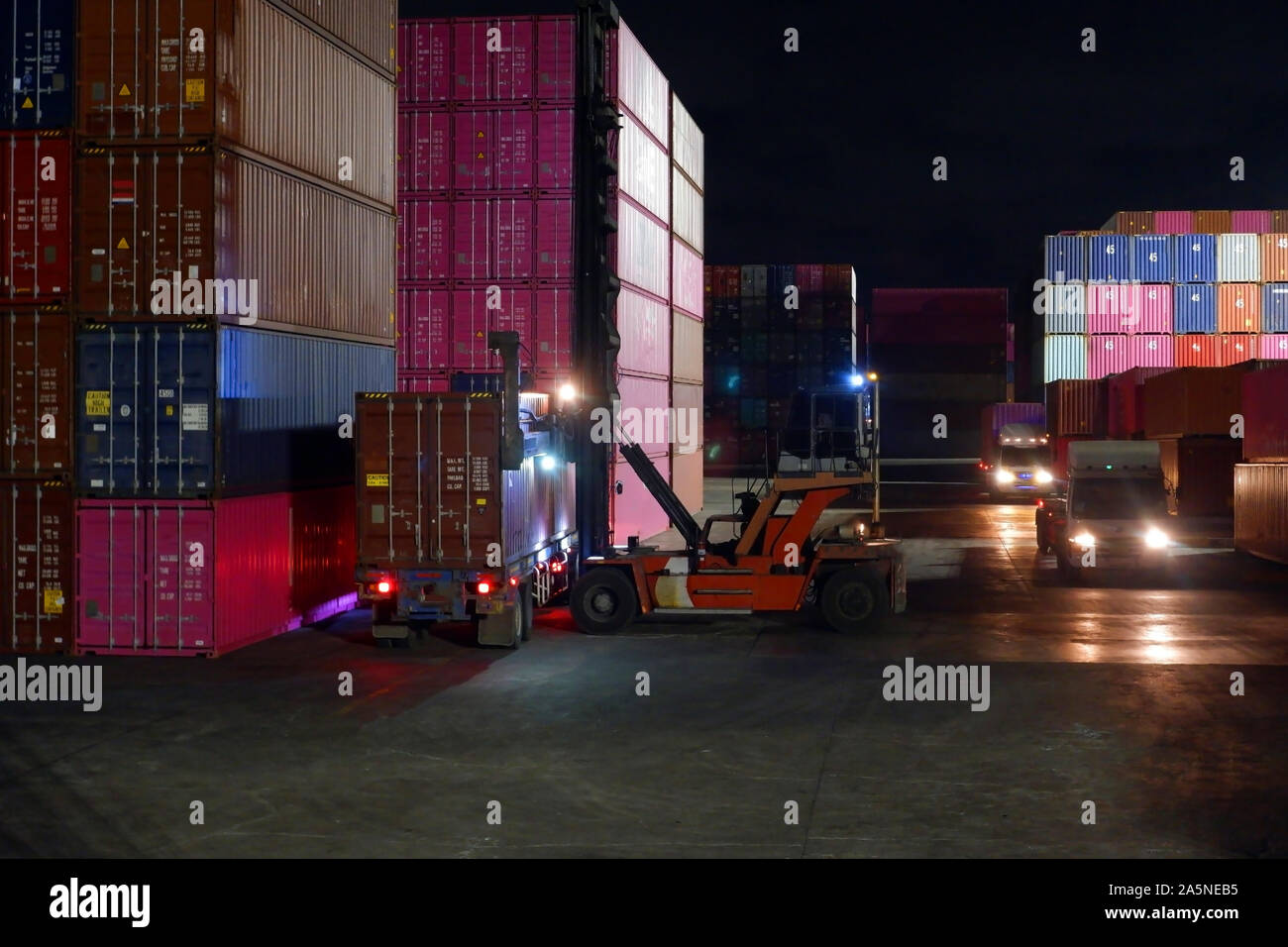 Container handlers Working in the container yard at night Stock Photo ...