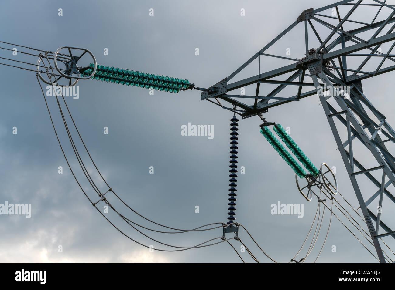 High voltage power lines and green insulators Stock Photo - Alamy