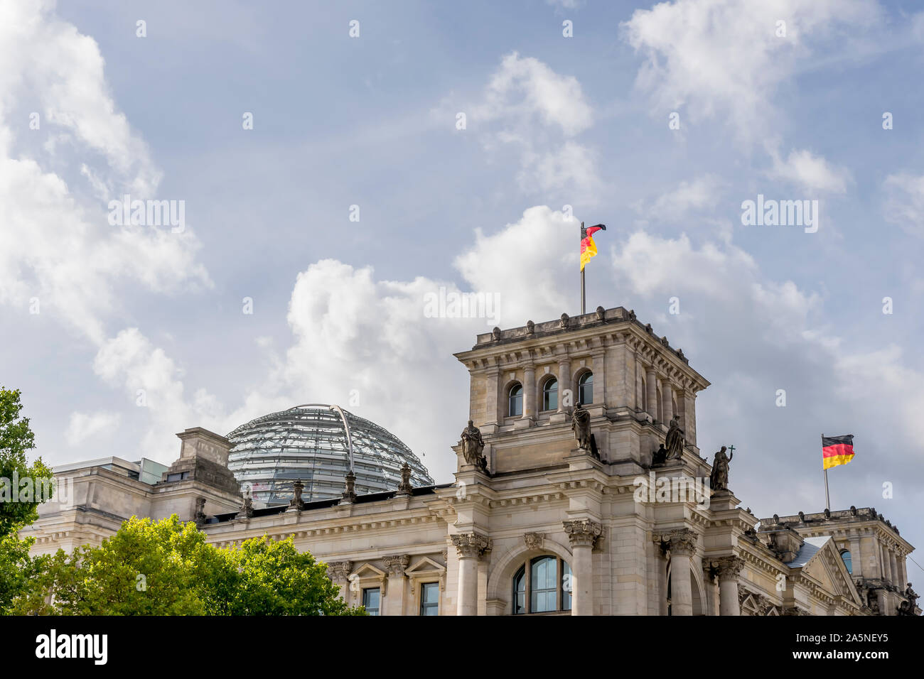 German flags waving on the Reichstag building in the historic center of ...