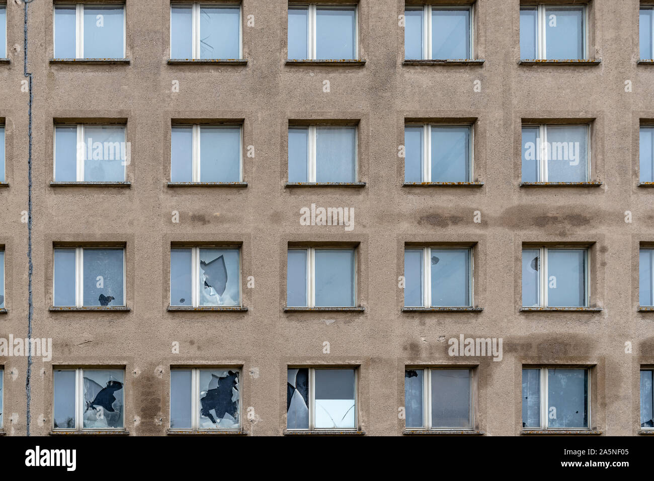 Full frame of array of windows with broken glass in old building facade ...