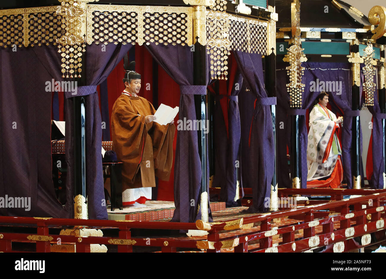 Tokyo, Japan. 22nd Oct, 2019. Japanese Emperor Naruhito (L) delivers a ...