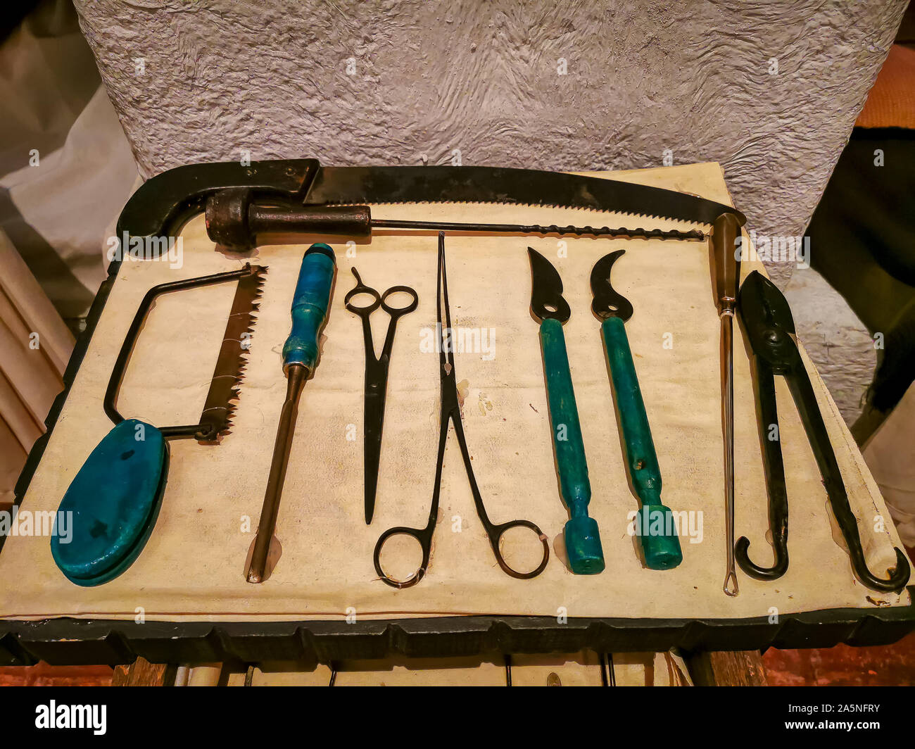 Set of colonial vintage medical instruments on a white cloth. The ...
